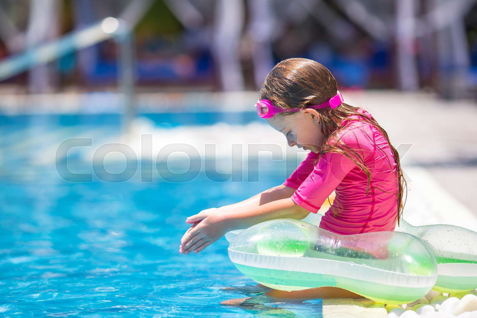 Smiling adorable girl having fun in outdoor swimming pool | Stock image ...