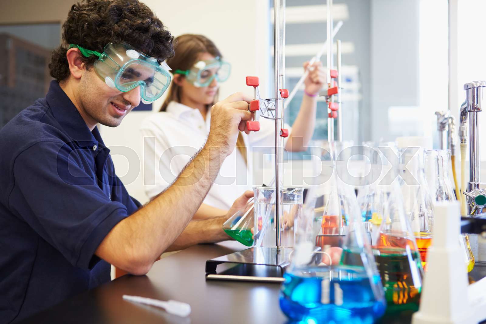 Pupils Carrying Out Experiment In Science Class | Stock image | Colourbox