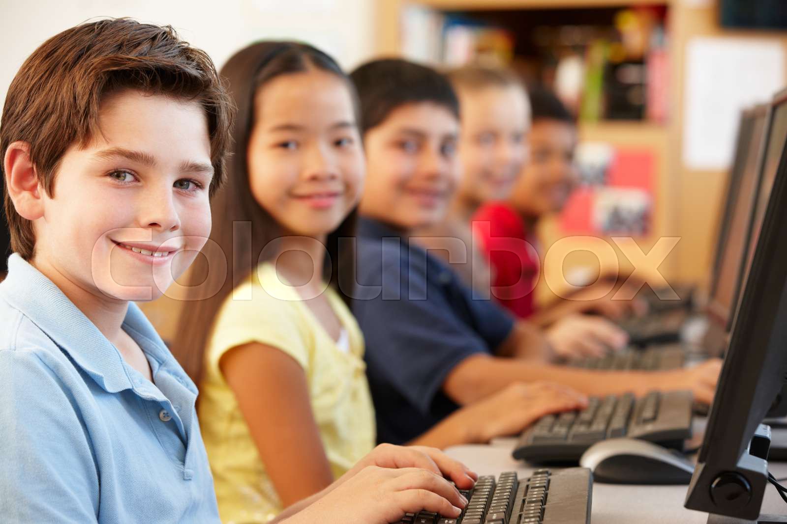 Schoolchildren working on computers | Stock image | Colourbox