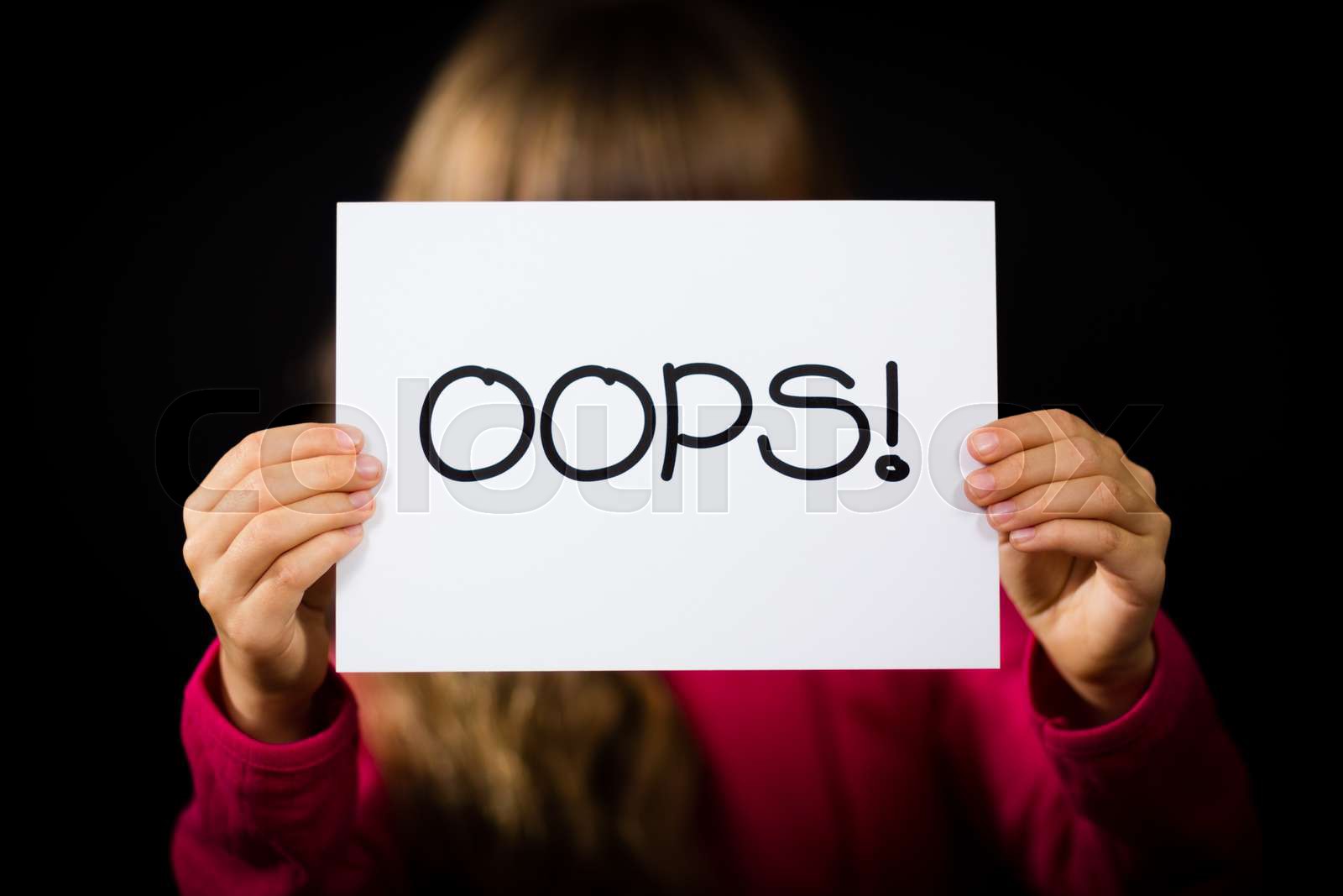 Child holding OOPS sign | Stock image | Colourbox