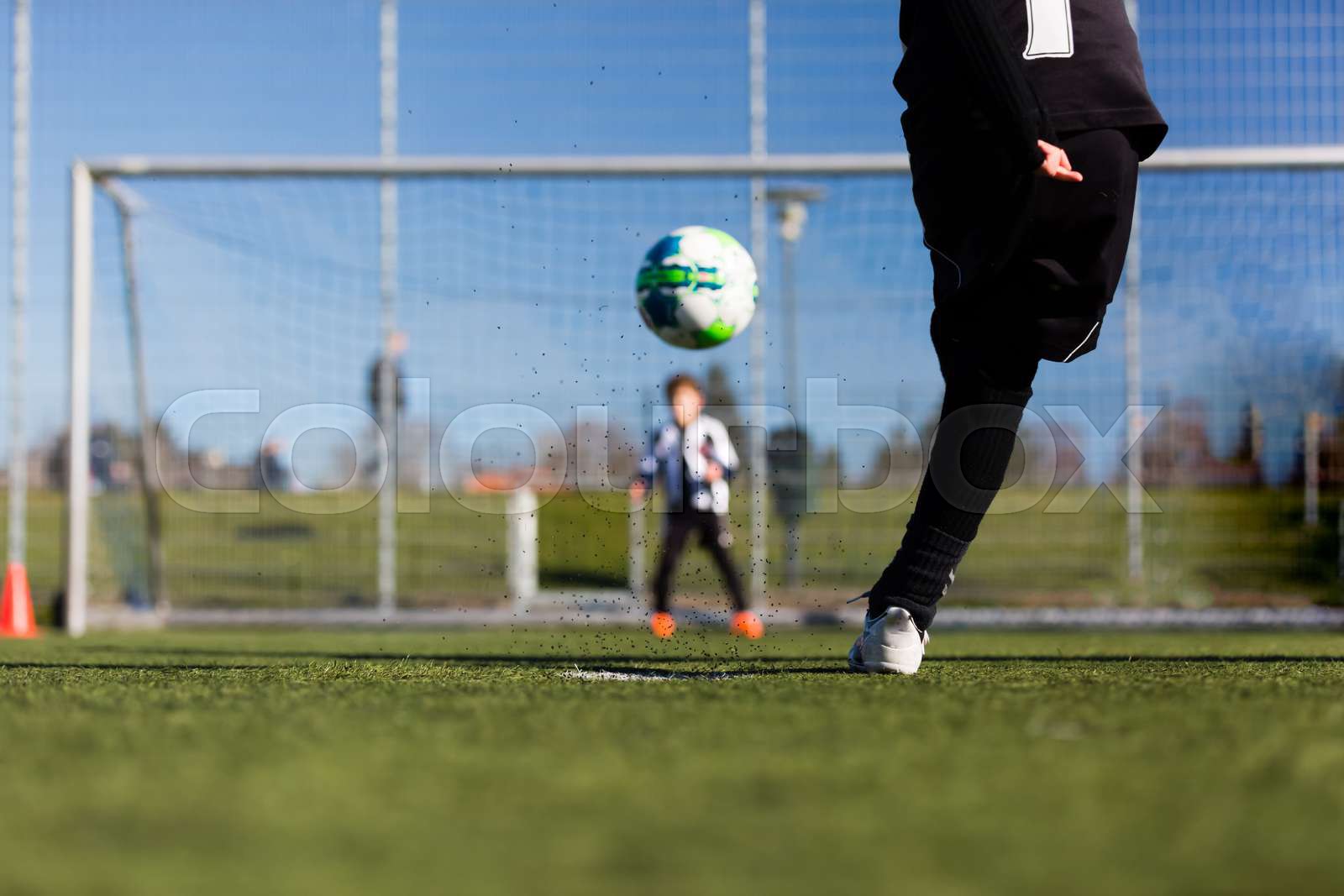 Soccer player and goalie during penalty shootout | Stock image | Colourbox