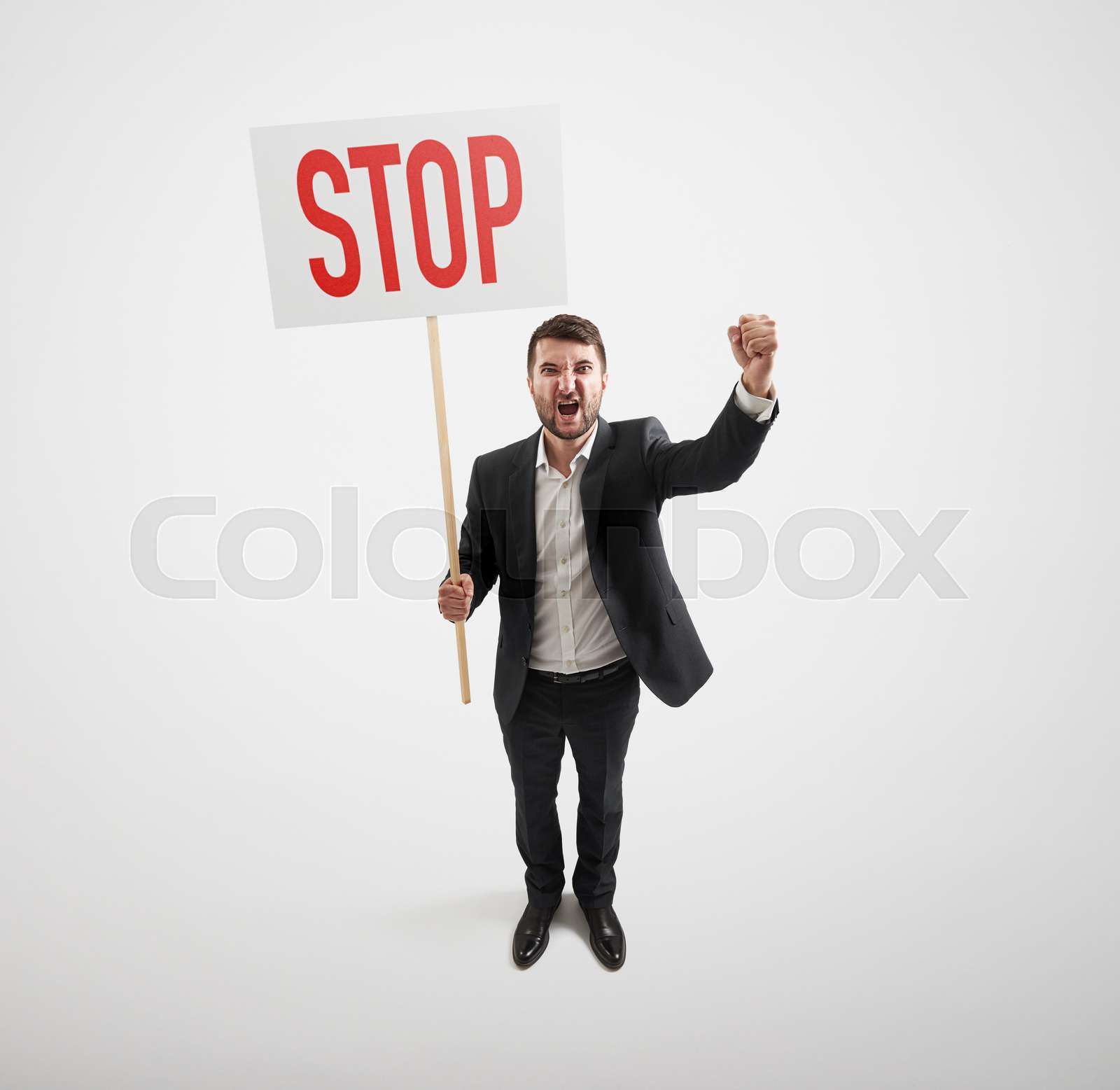 man holding placard with stop sign | Stock image | Colourbox