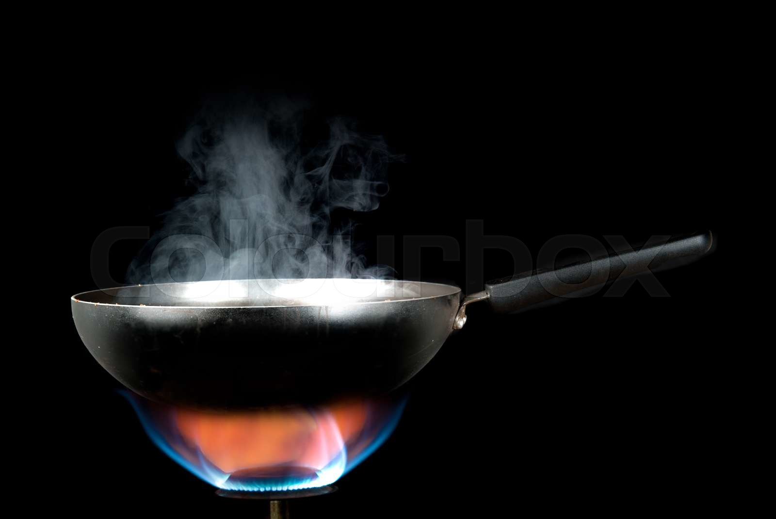 Frying Pan and smoke on Burner | Stock image | Colourbox
