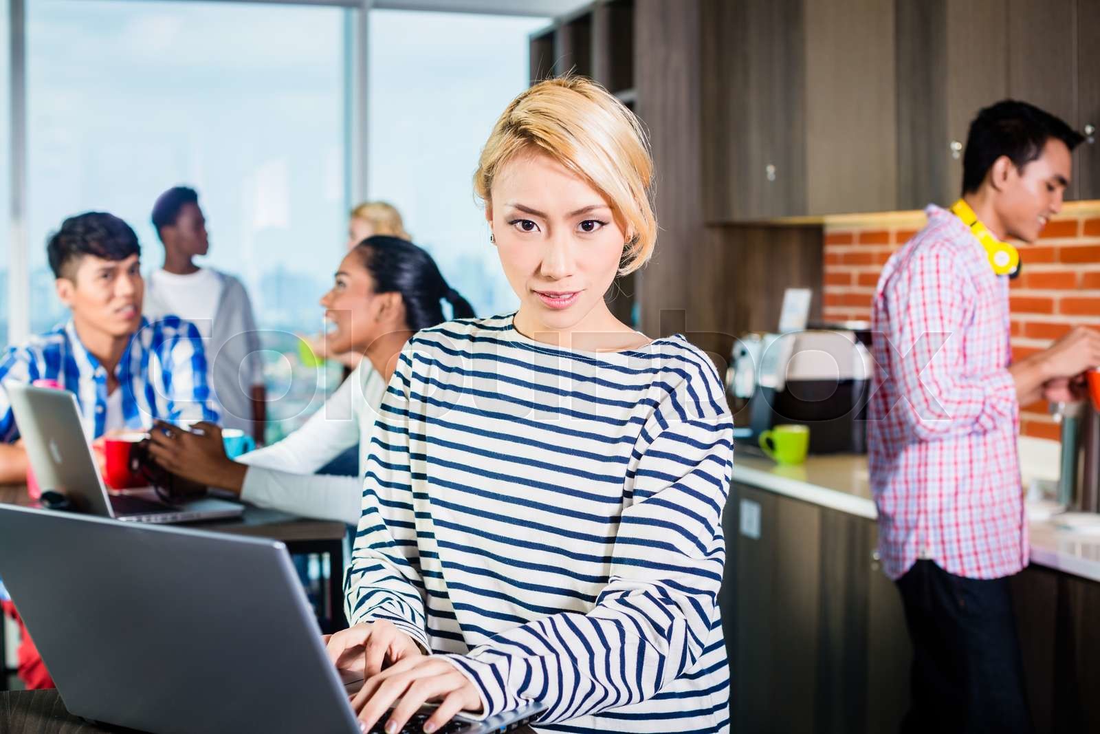 Chinese programmer in lounge of IT start-up | Stock image | Colourbox