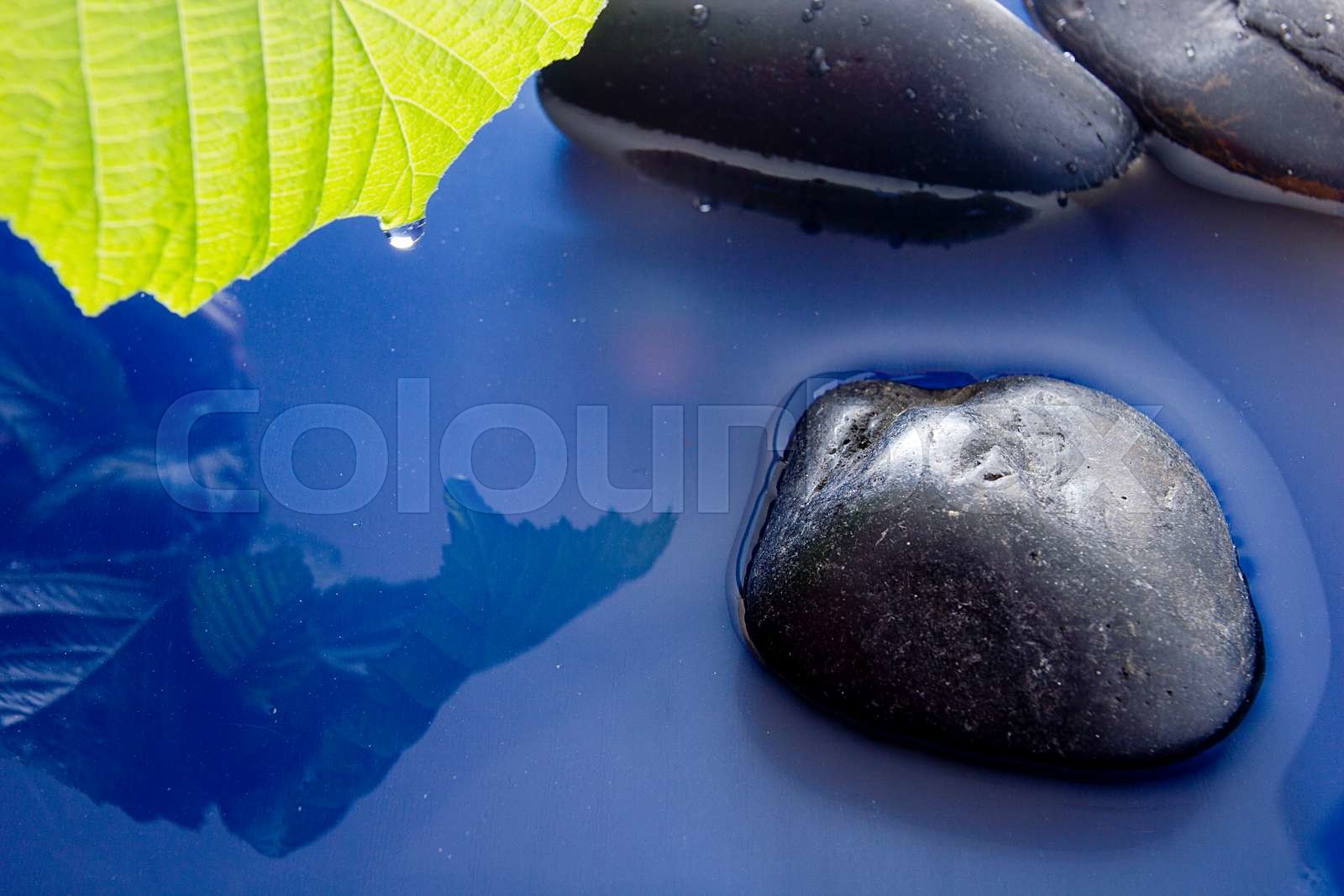 Smooth stones in water | Stock image | Colourbox