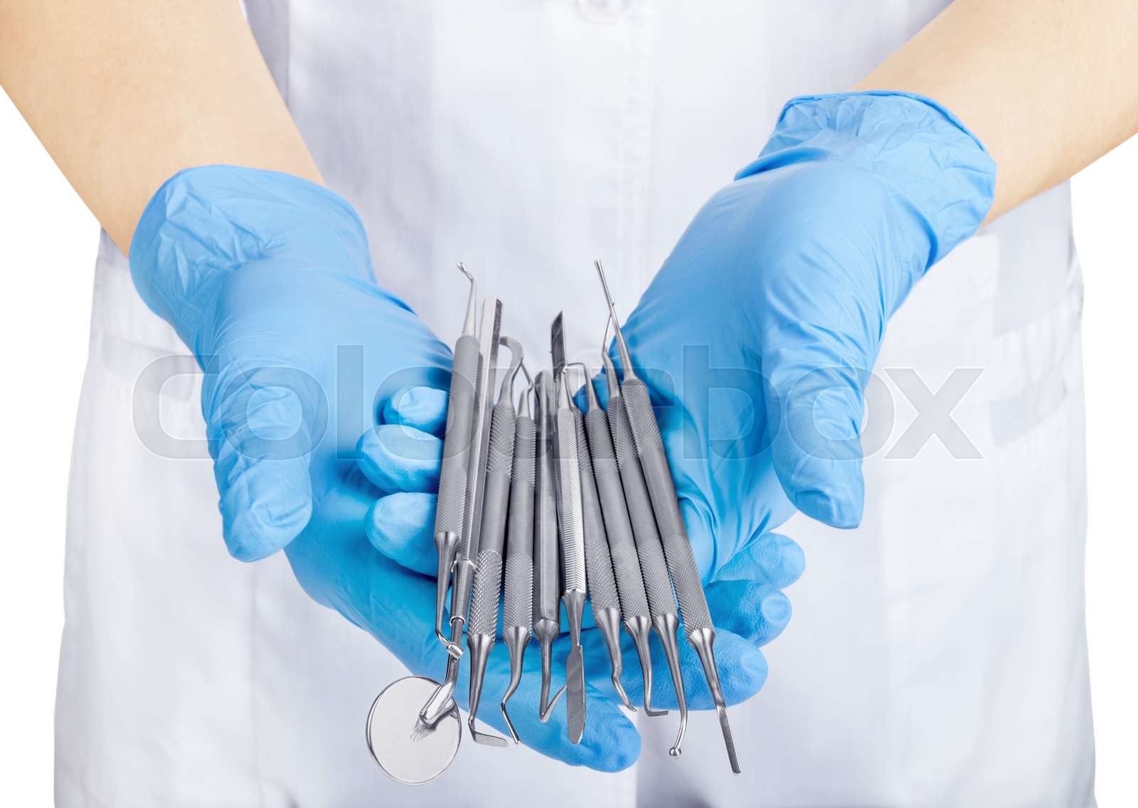 hands holding dental instruments | Stock image | Colourbox