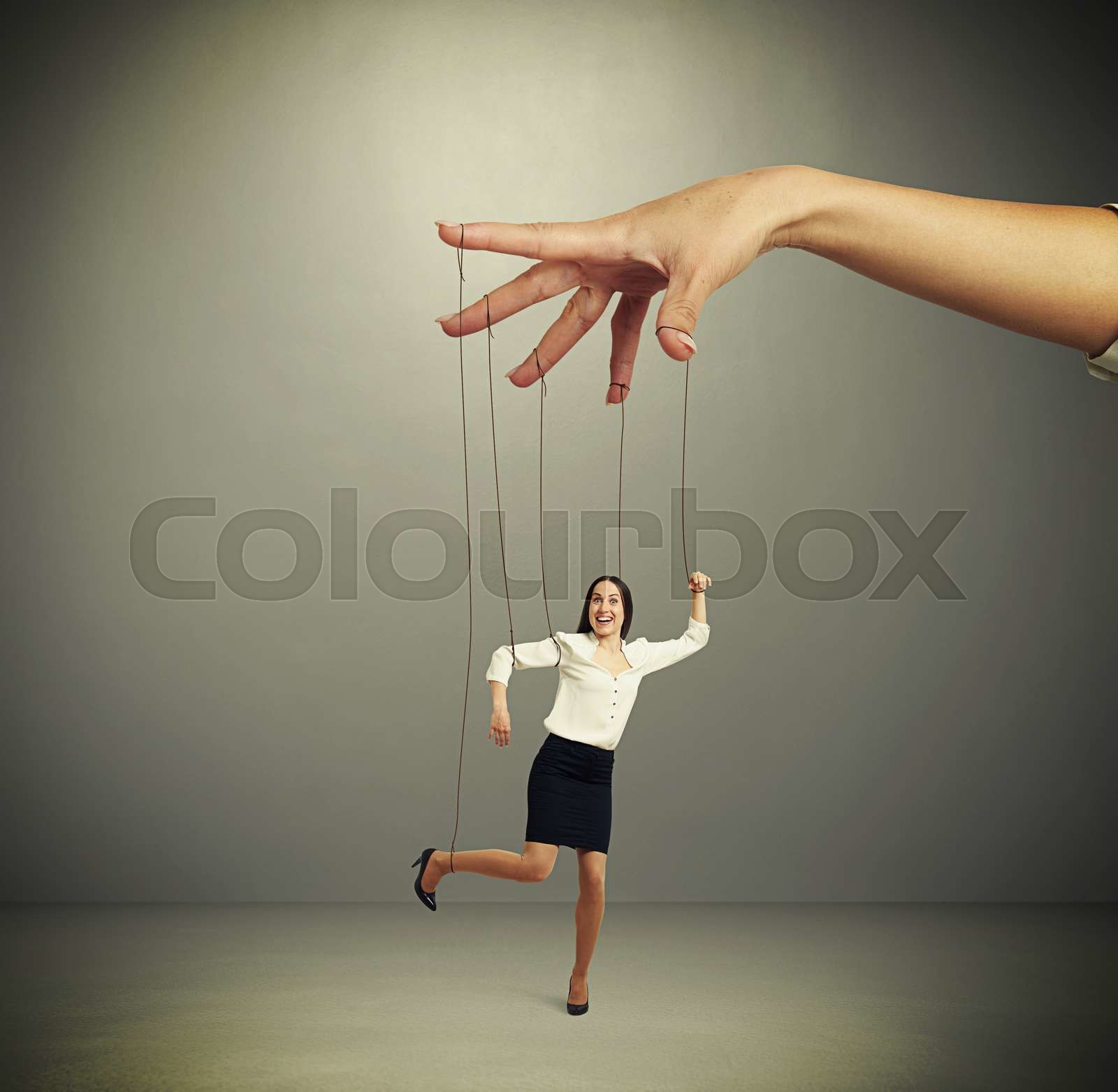 womans hand manipulating puppet | Stock image | Colourbox