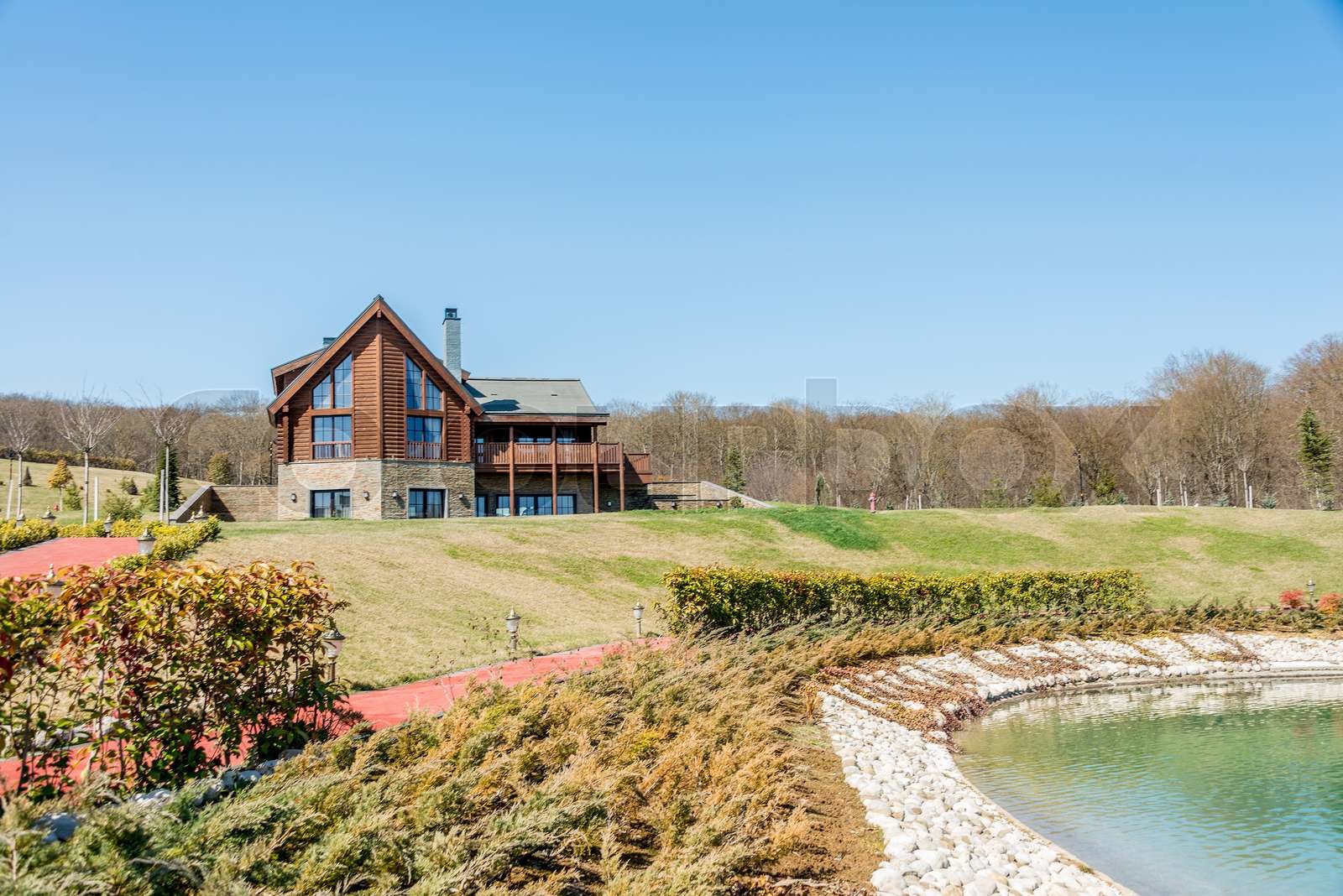 Modern house near water on bright day | Stock image | Colourbox