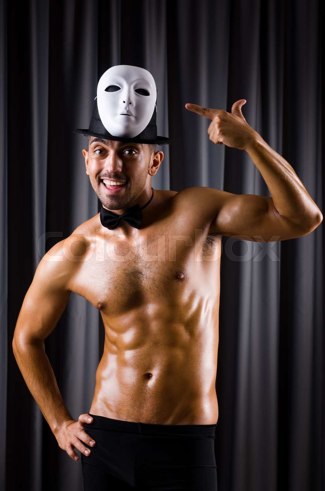 Muscular actor with theatrical mask | Stock image | Colourbox