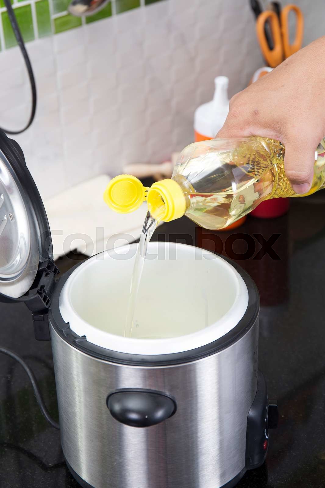 Chef pouring vegetable oil | Stock image | Colourbox
