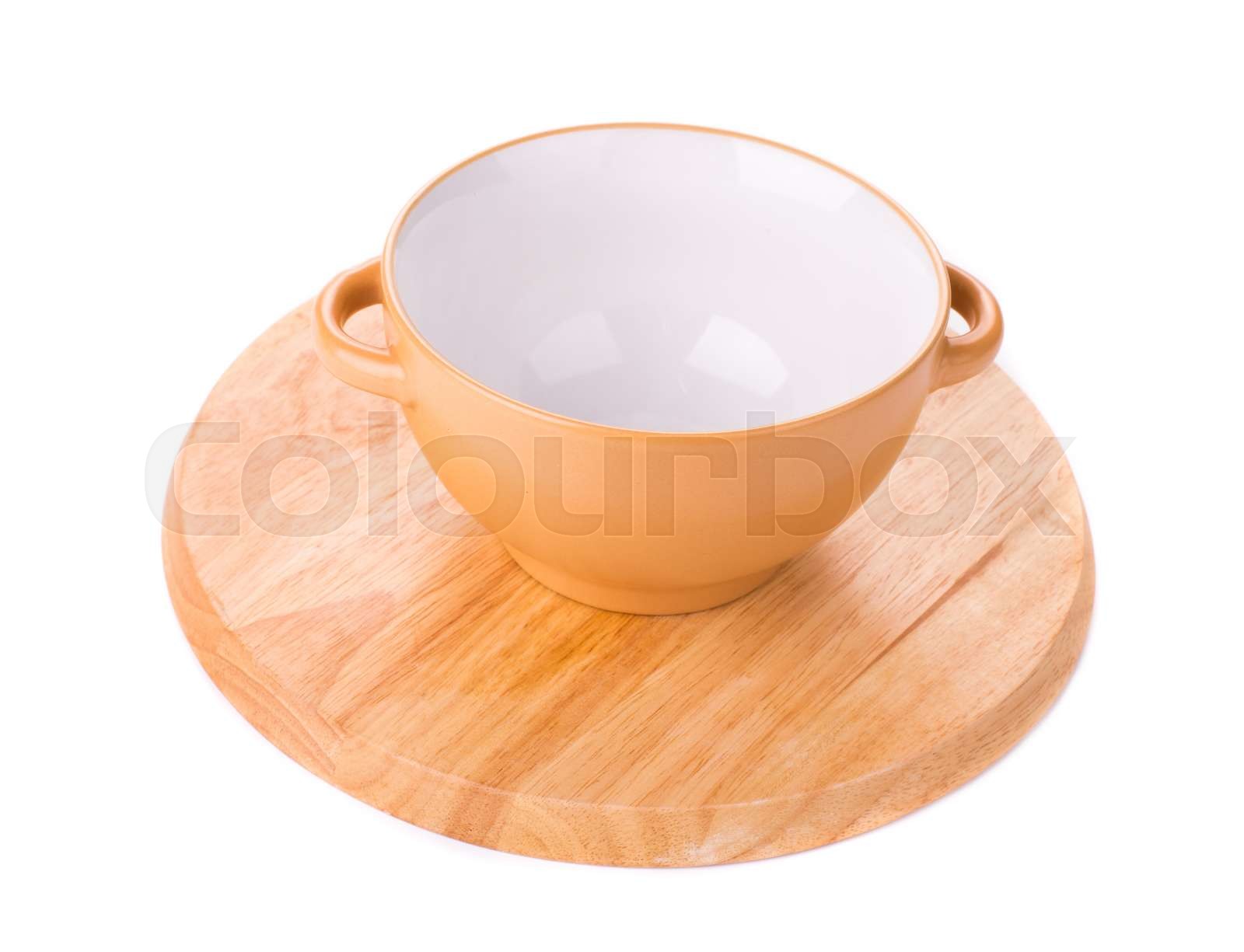 Soup bowl on wood platter. | Stock image | Colourbox