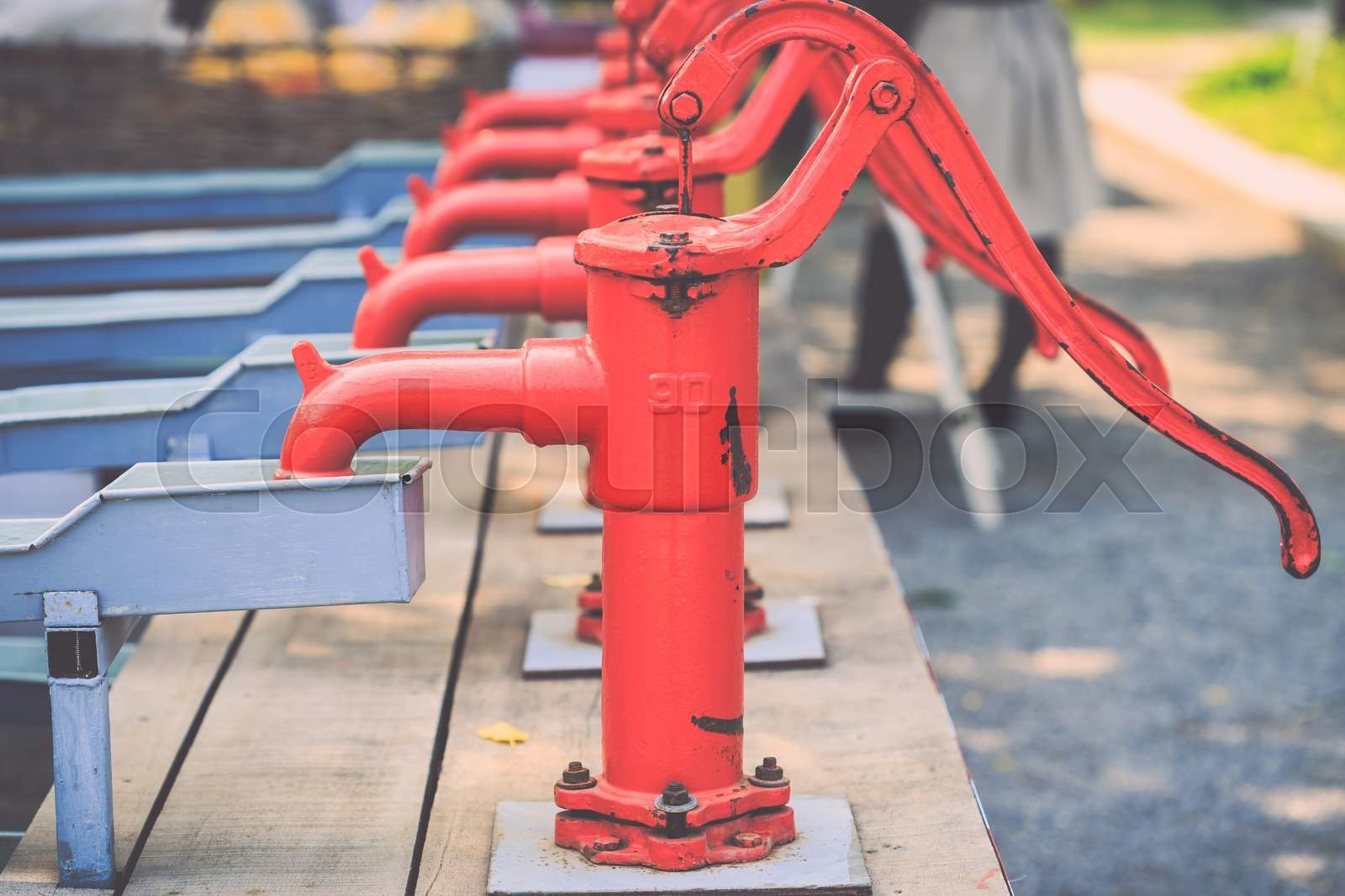 Red retro style hand water pump | Stock image | Colourbox