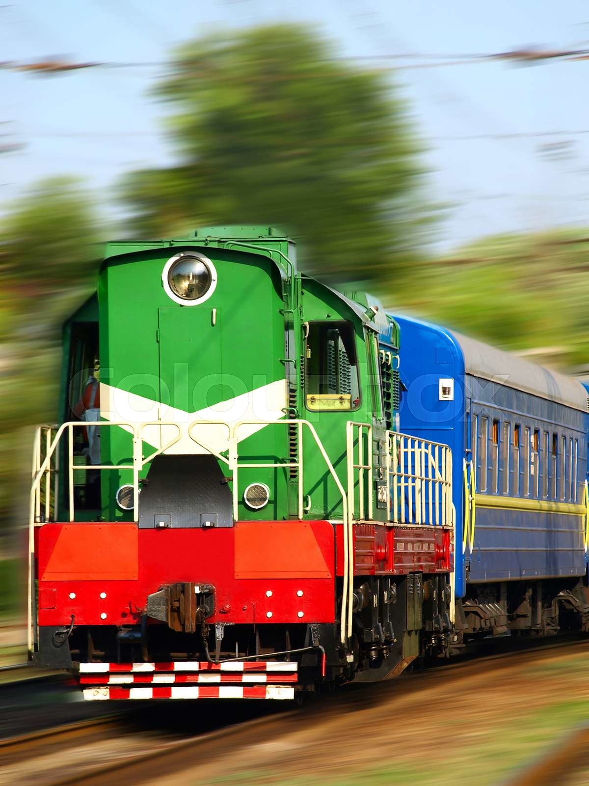Fast locomotive and passenger cars in movement. | Stock image | Colourbox