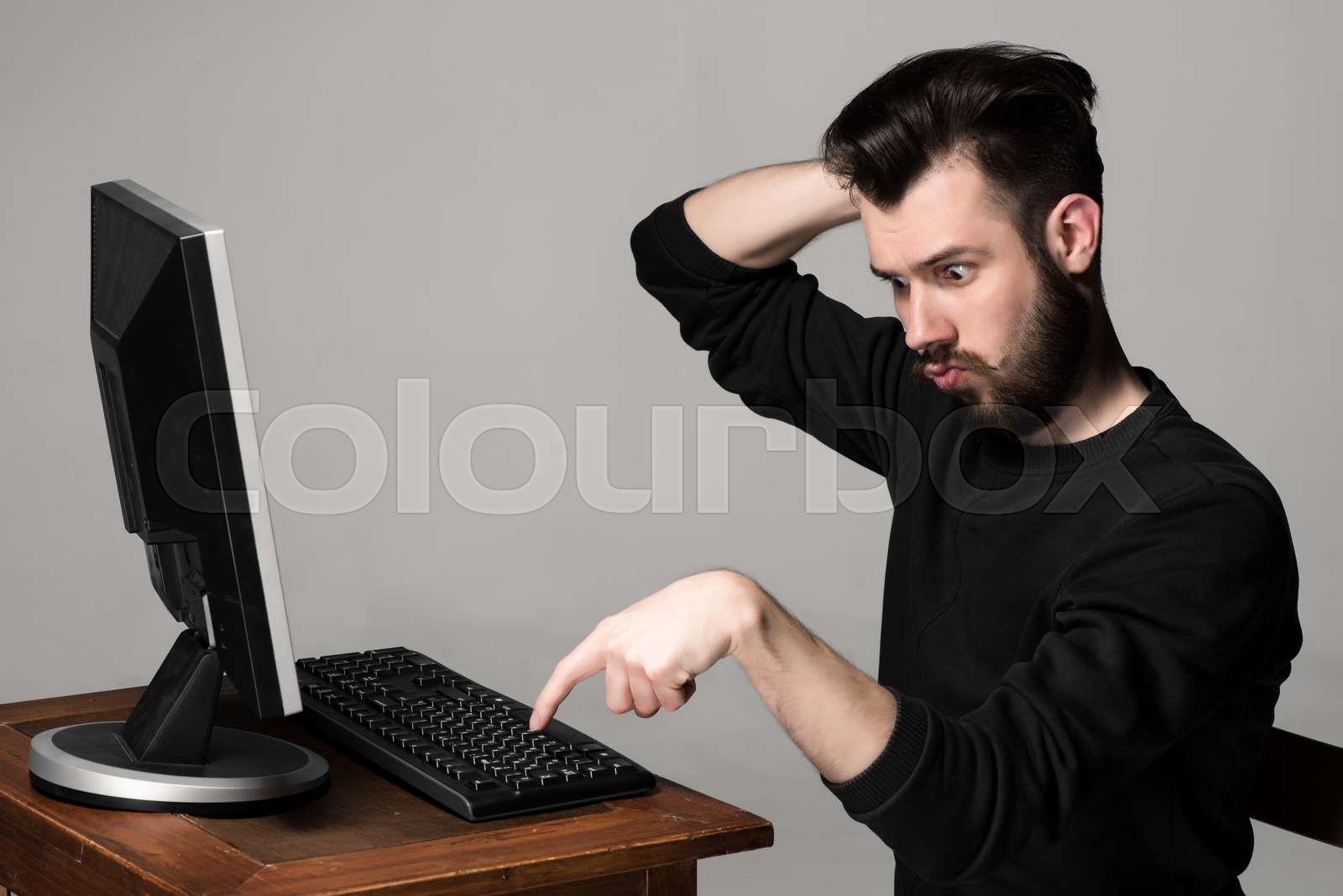 Funny and crazy man using a computer | Stock image | Colourbox