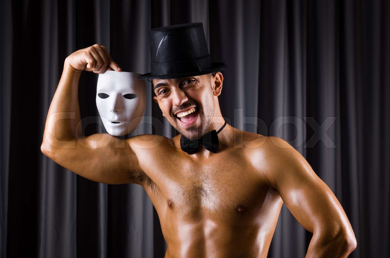 Muscular actor with theatrical mask | Stock image | Colourbox