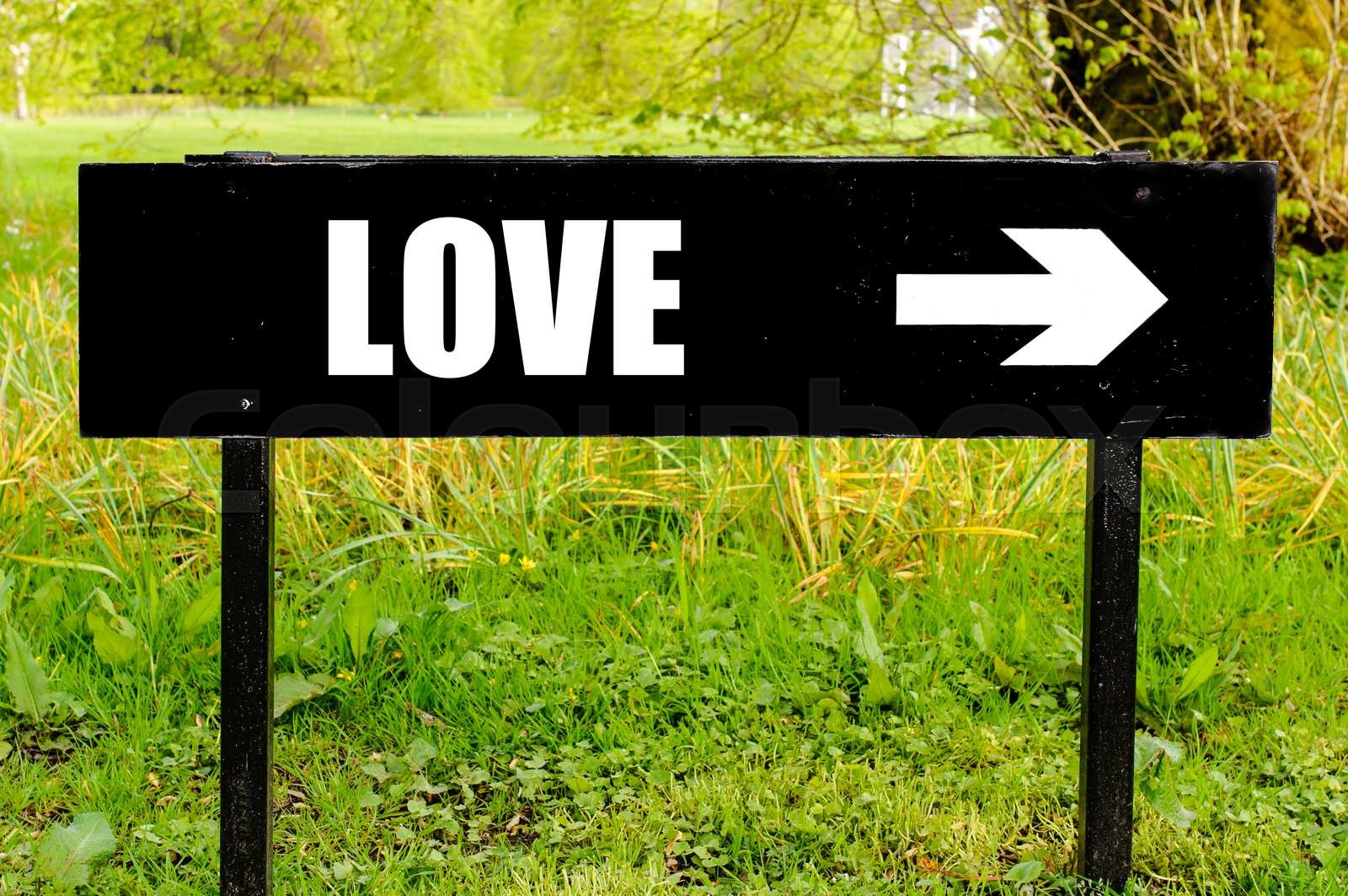 LOVE written on directional black metal sign | Stock image | Colourbox