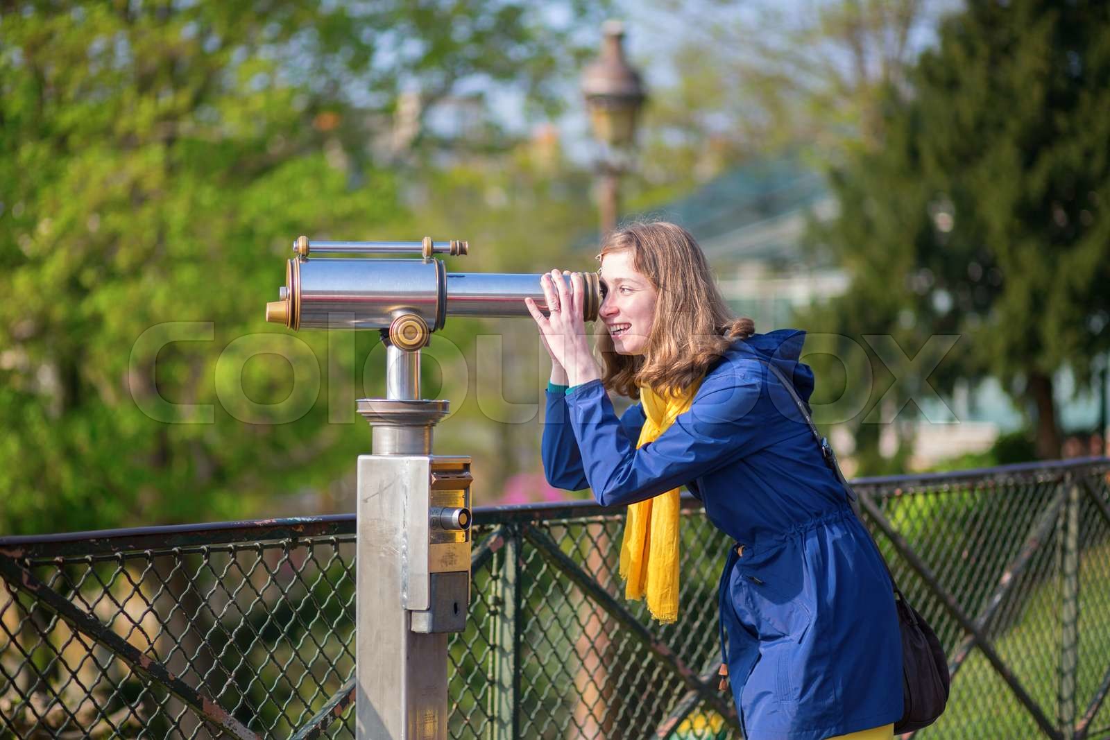 Girl using telescope for sightseeing | Stock image | Colourbox