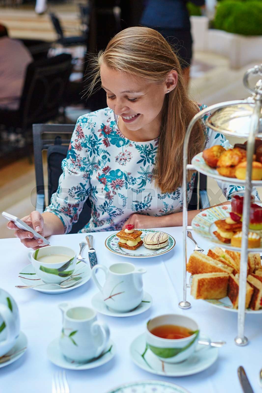 Beautiful young woman enjoying afternoon tea | Stock image | Colourbox