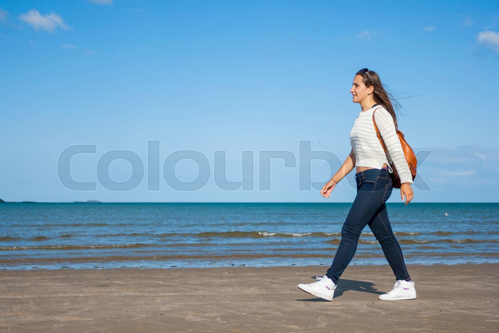 Teen walking on the beach | Stock image | Colourbox