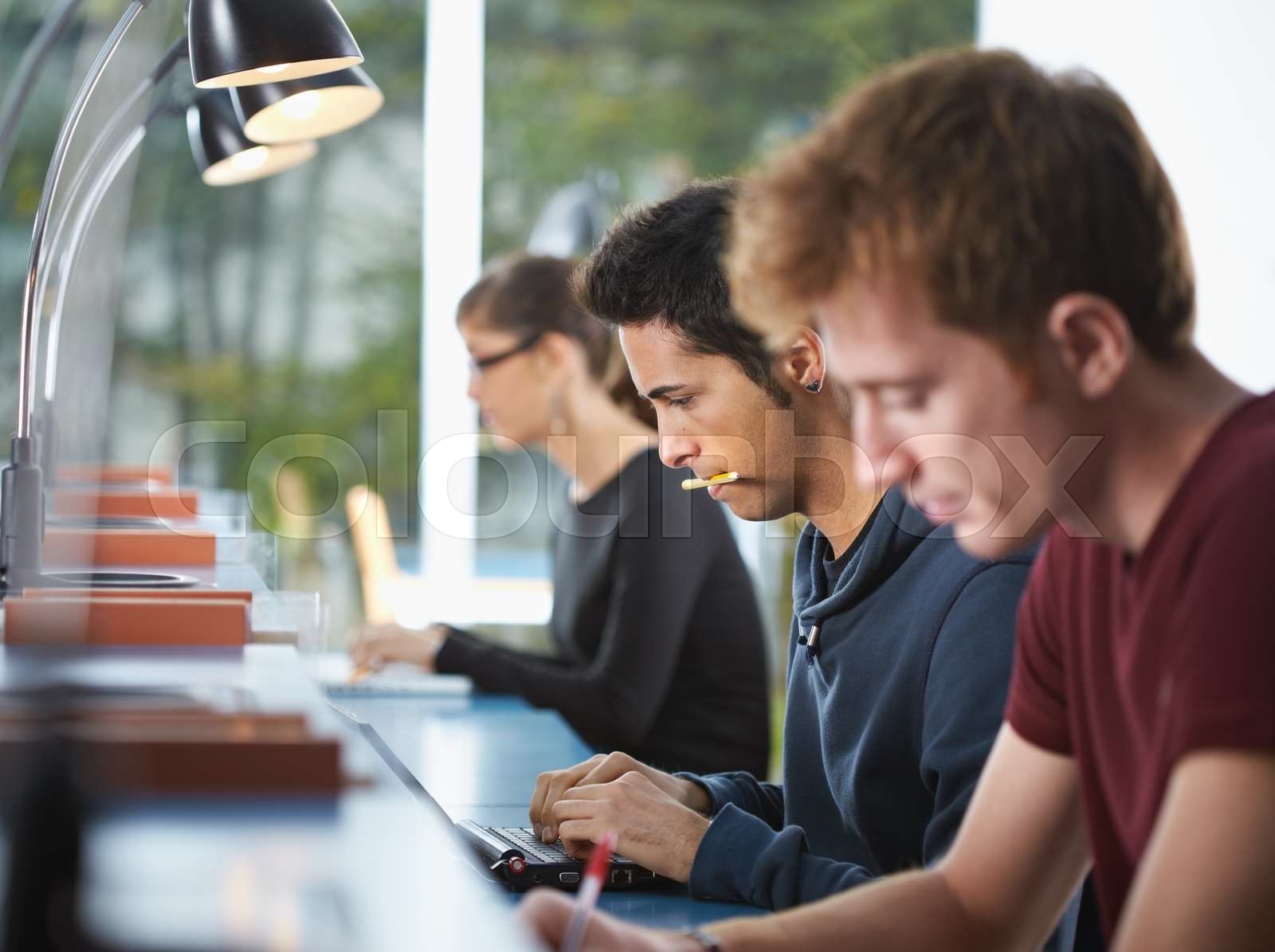 group of three people in library | Stock image | Colourbox