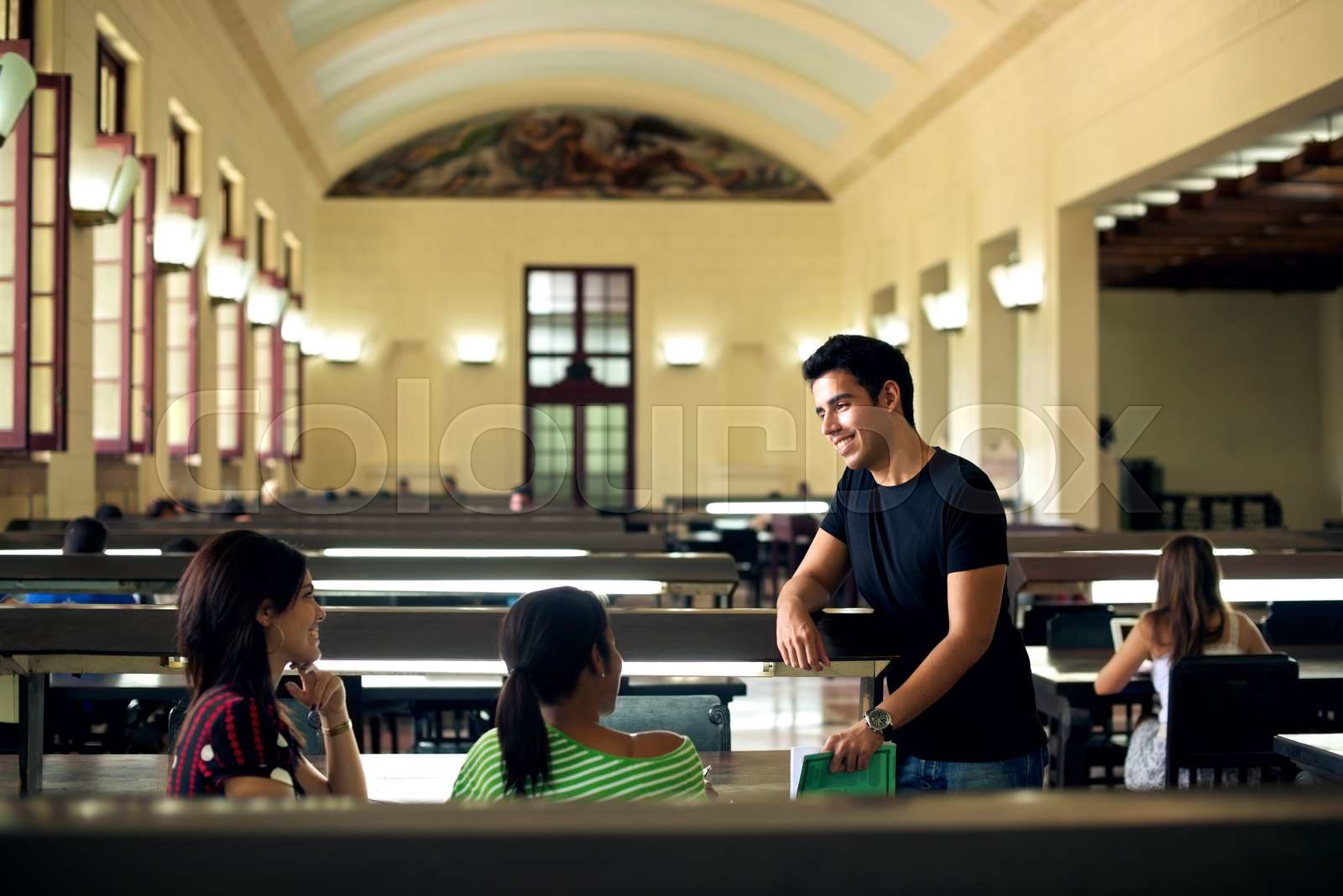 Group of happy students and friends studying in school library | Stock ...