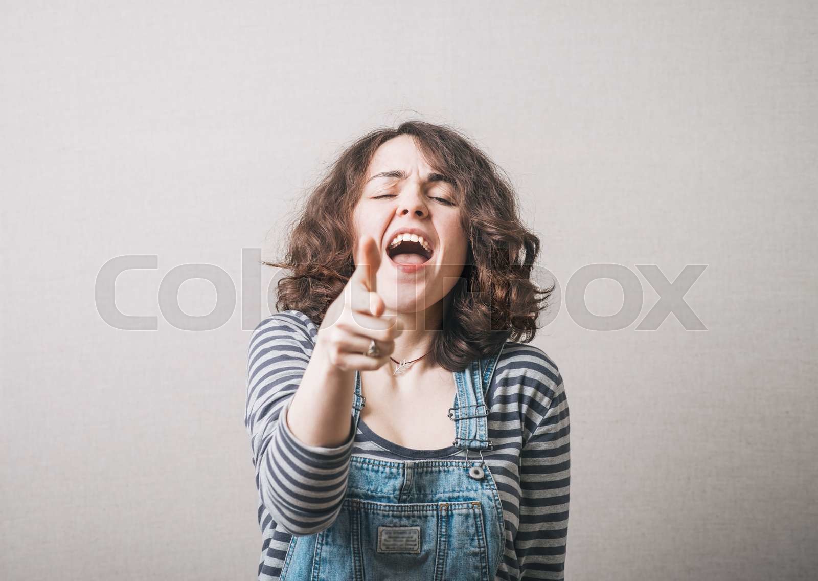 Funny Cute Brunette Girl Points Finger And Taunts Stock Image Colourbox