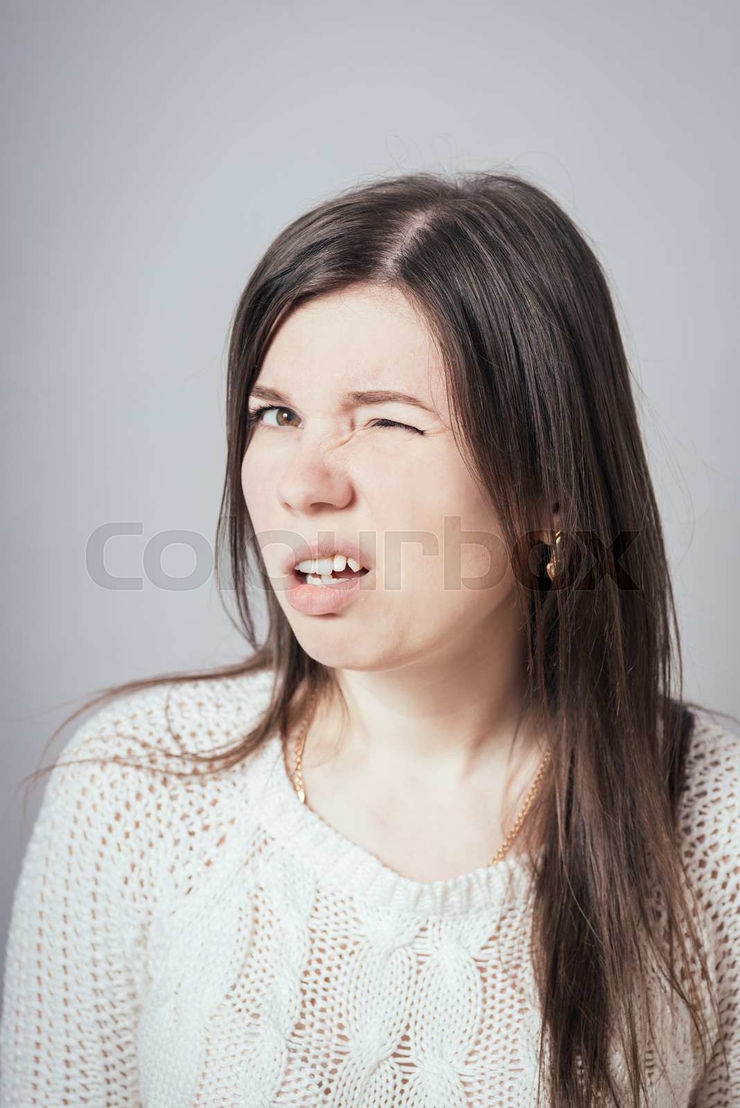 Girl blinking one eye | Stock image | Colourbox