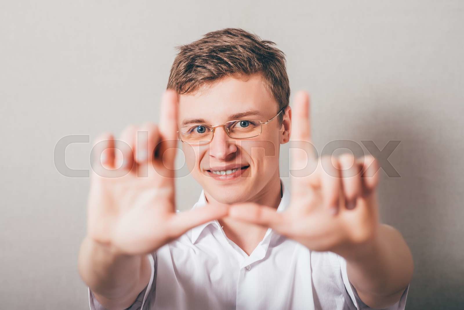 young guy making a frame arms | Stock image | Colourbox