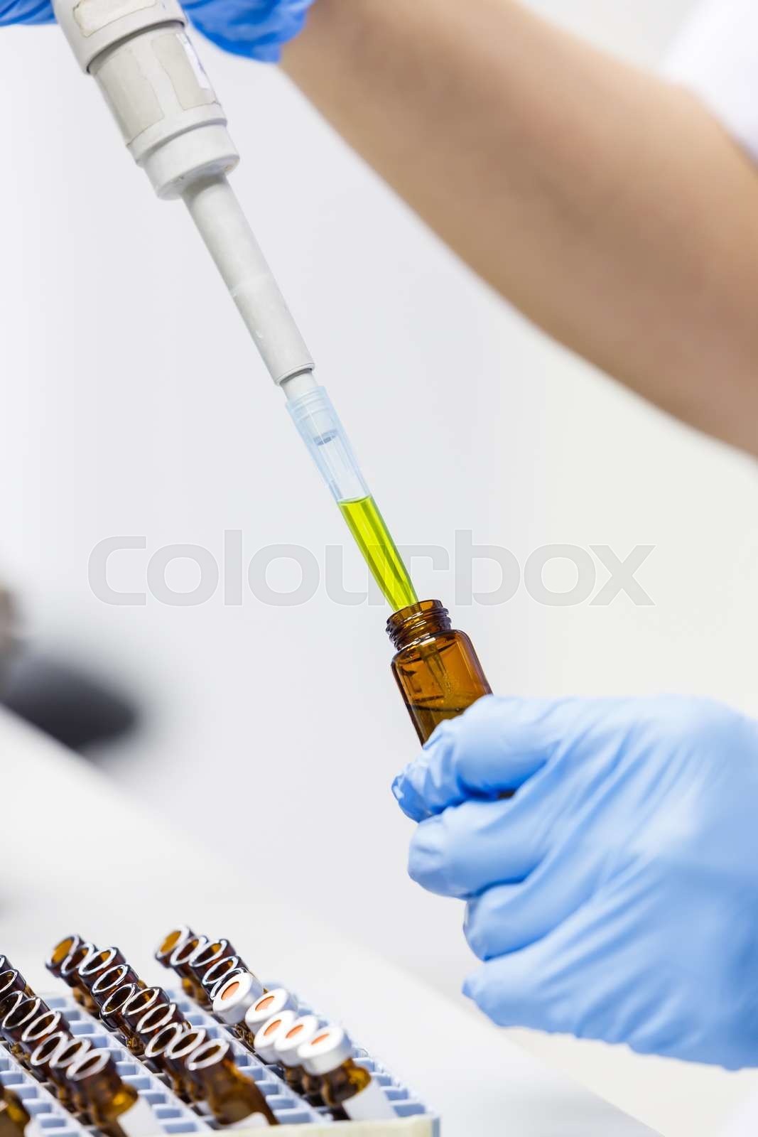 Using auto pipette | Stock image | Colourbox
