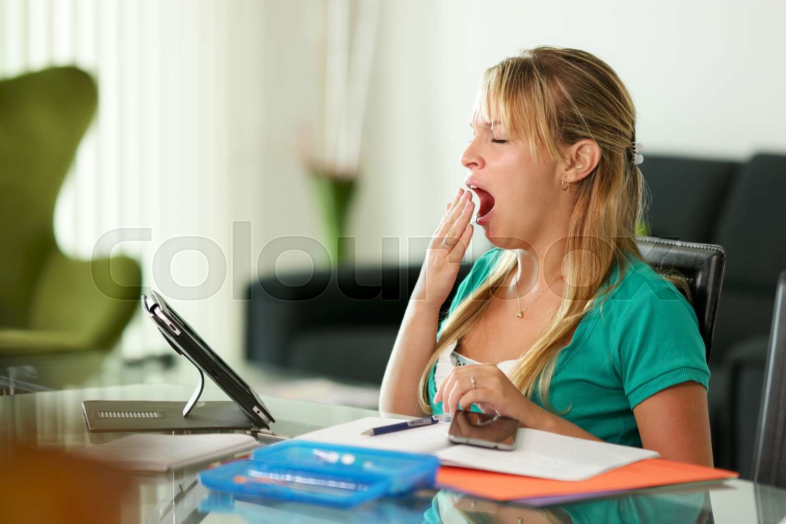 Young woman female student yawning while studying | Stock image | Colourbox