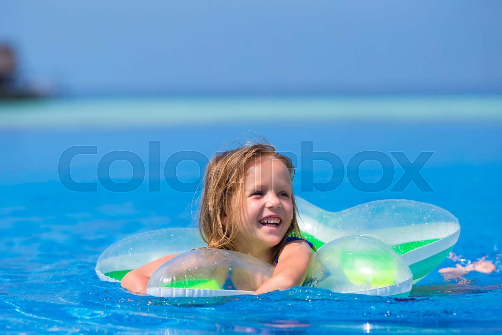 Little happy adorable girl in outdoor swimming pool | Stock image ...