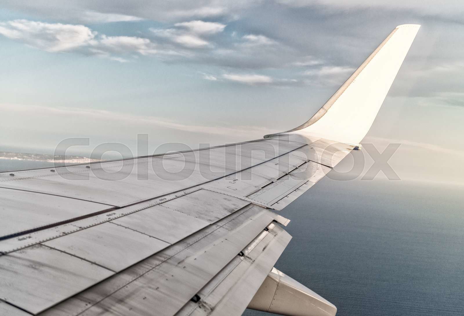 Airplane wing in the sky while flying | Stock image | Colourbox
