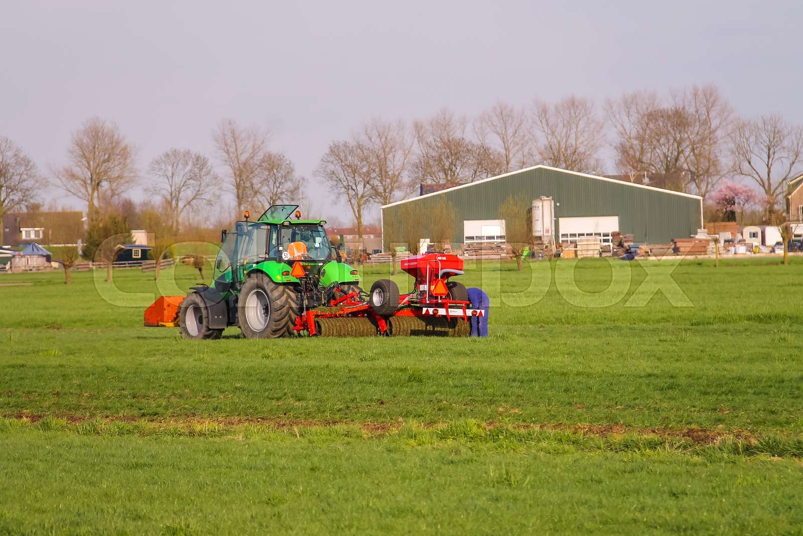 Tractor operator on the tractor carries out field work | Stock image ...