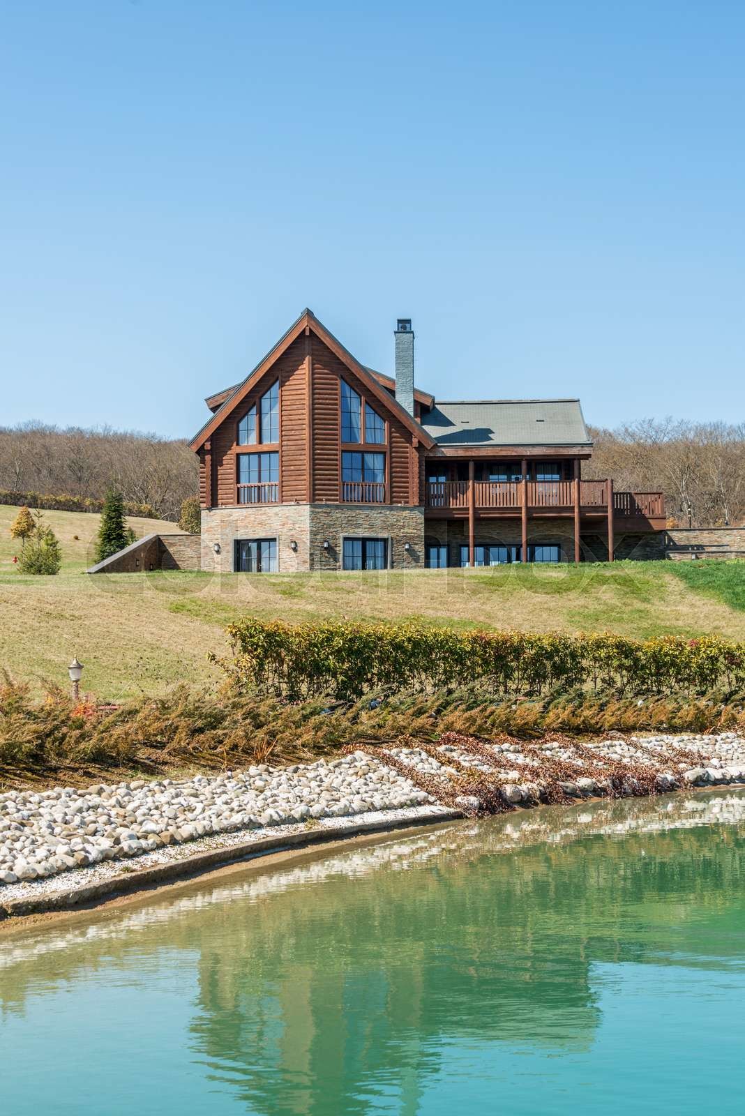Modern house near water on bright day | Stock image | Colourbox