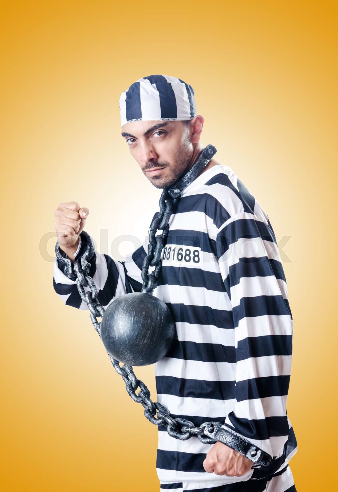 Convict criminal in striped uniform | Stock image | Colourbox