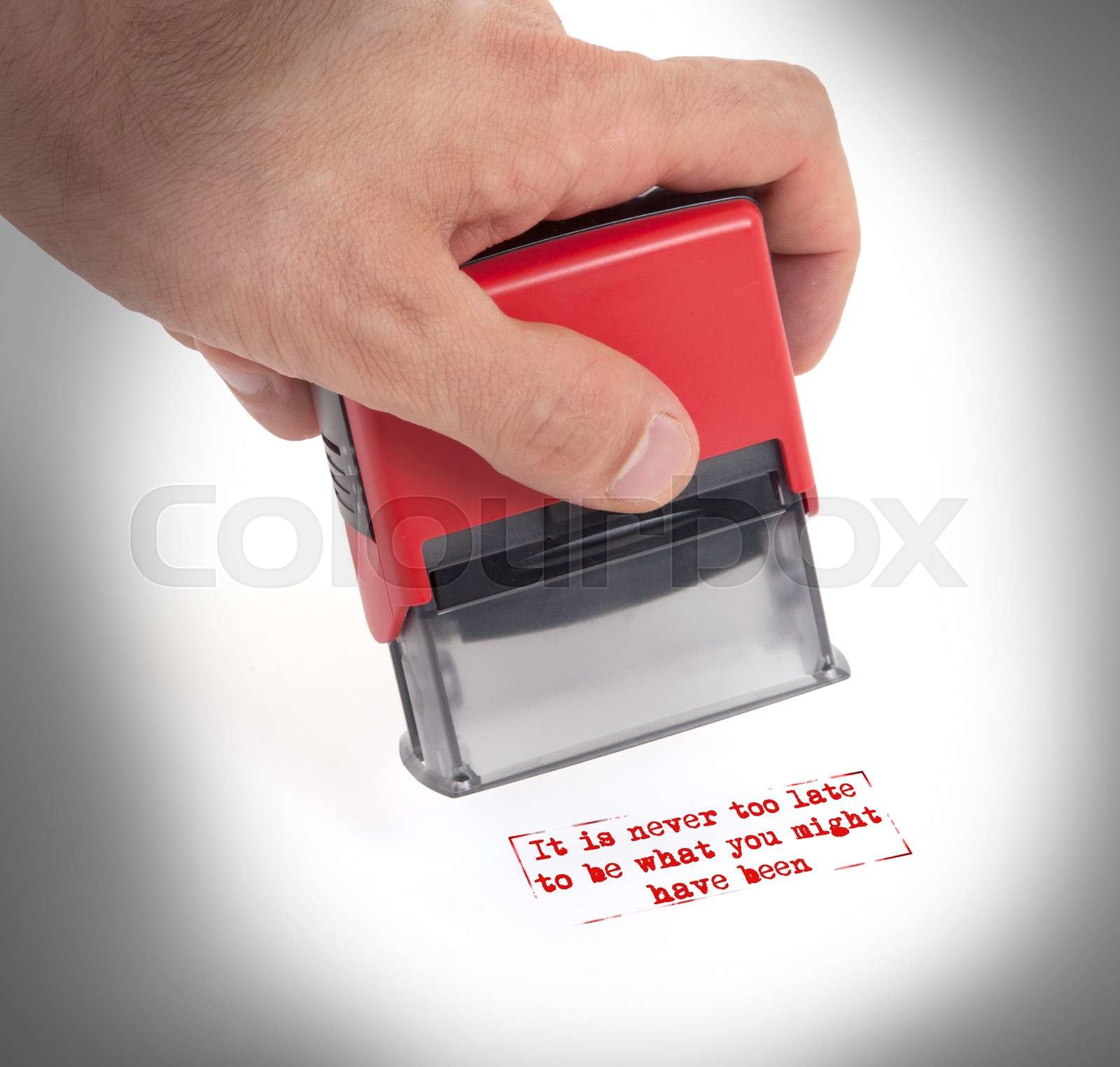 Plastic stamp in hand, isolated | Stock image | Colourbox