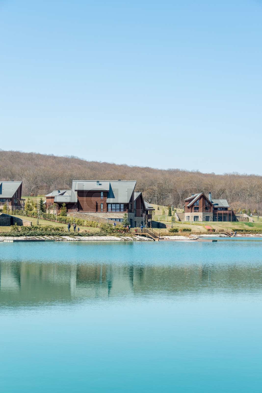 Modern house near water on bright day | Stock image | Colourbox