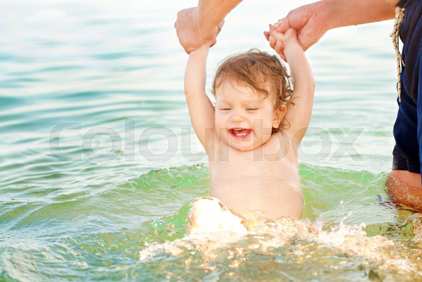 Dad teaching kid to swim. | Stock image | Colourbox