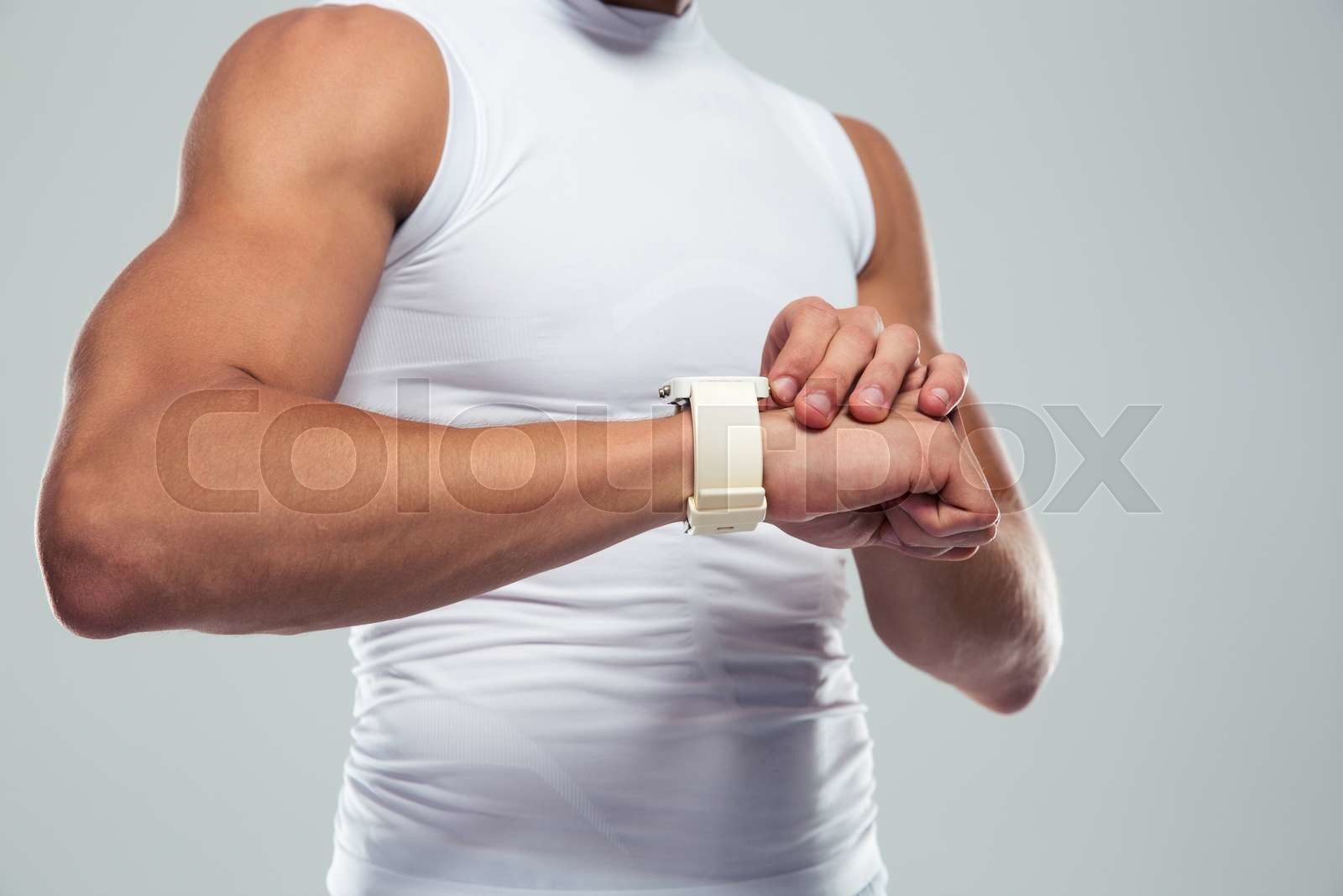 Closeup portrait of a muscular man using smartwatch | Stock image ...