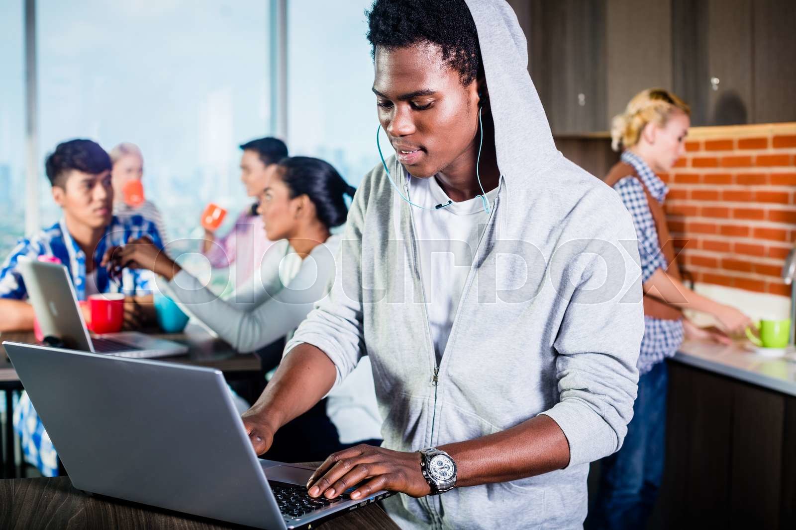 Black programmer in lounge of IT start-up | Stock image | Colourbox