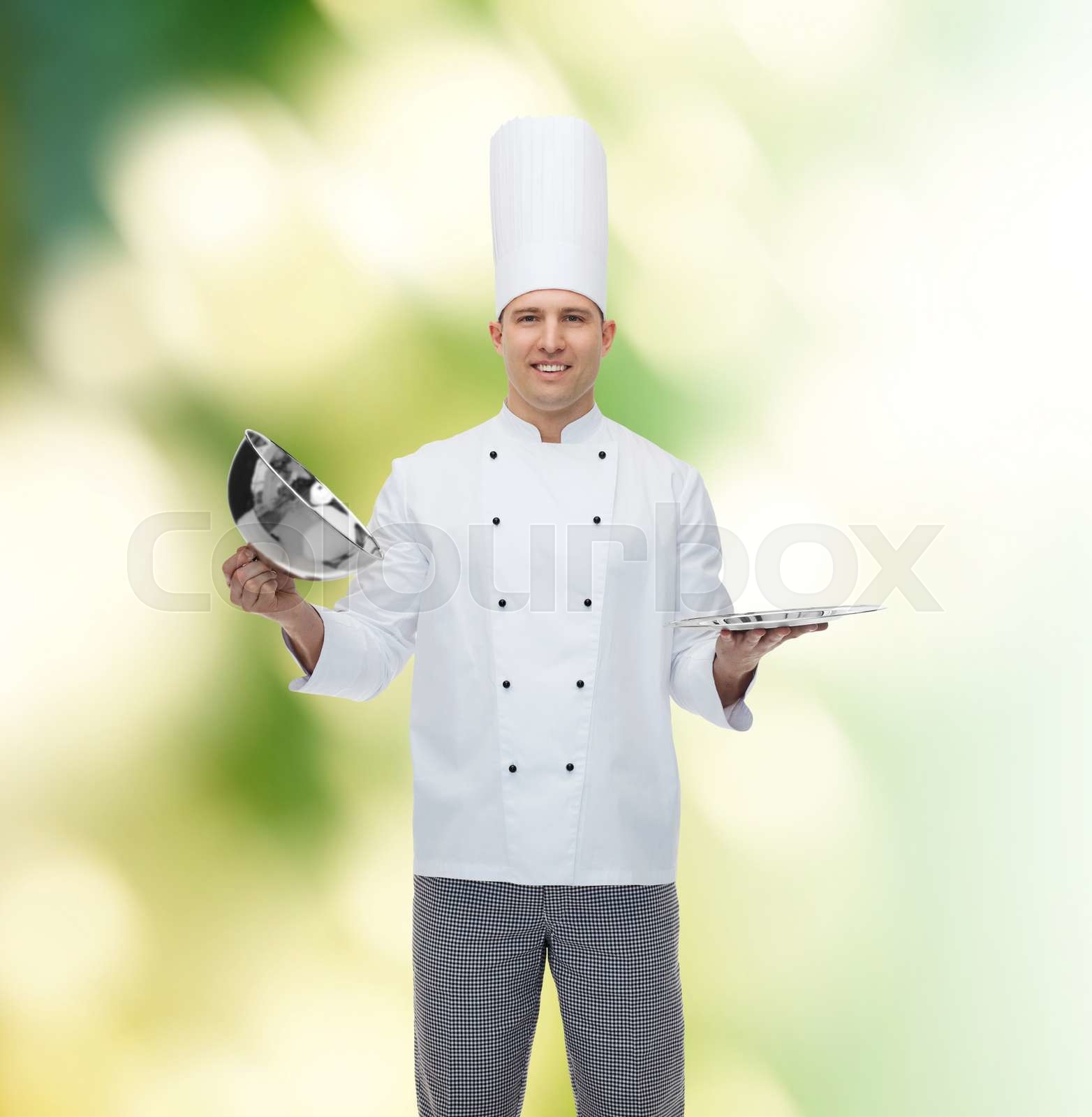 happy male chef cook opening cloche | Stock image | Colourbox