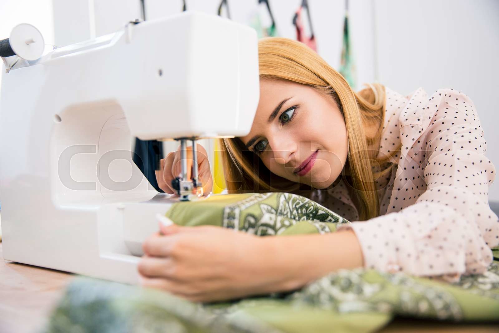 Female tailor using sewing machine | Stock image | Colourbox