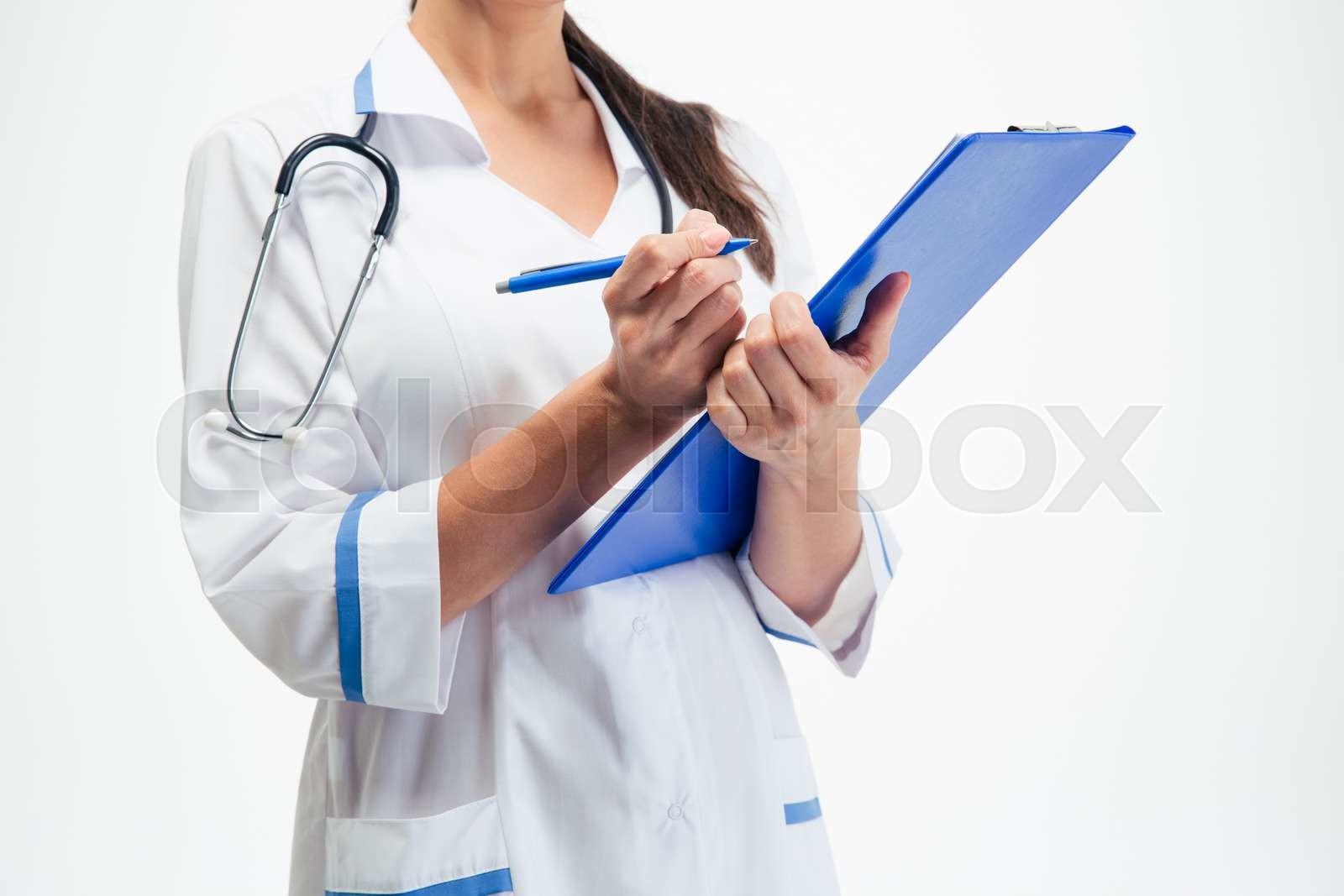 Doctor writing notes in clipboard | Stock image | Colourbox