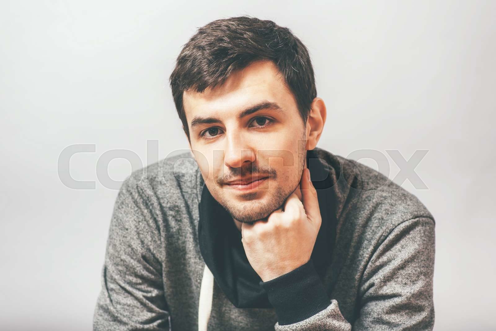 man propped his chin with his fist | Stock image | Colourbox