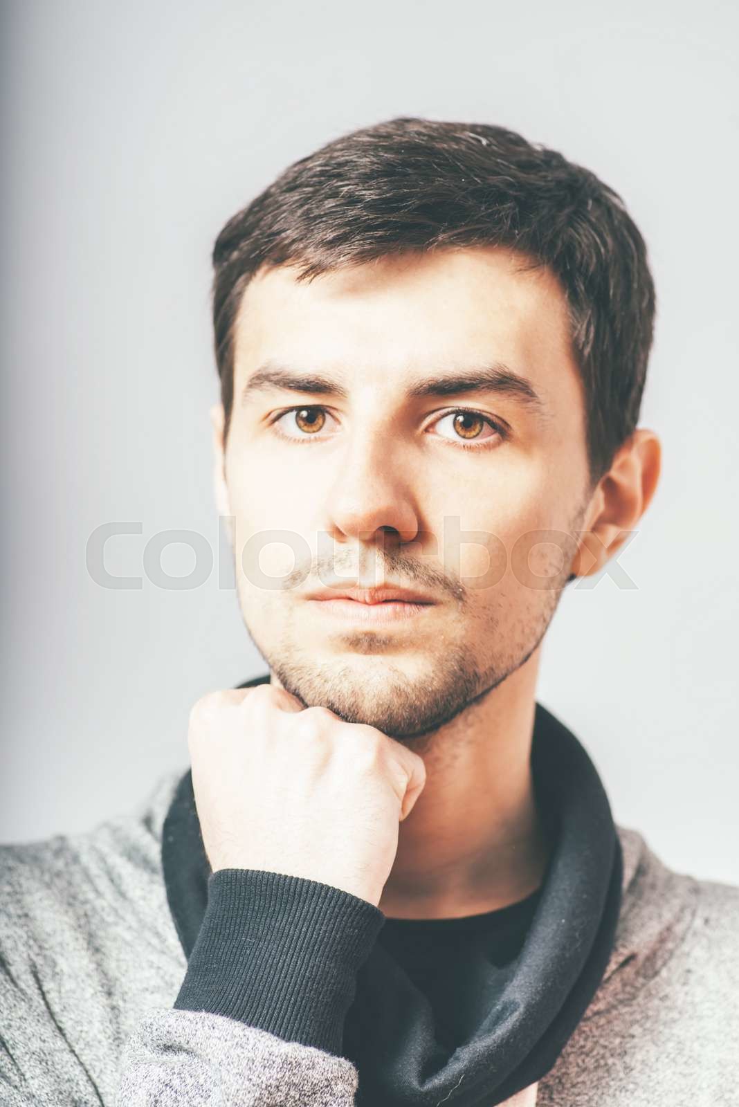man propped his chin with his fist | Stock image | Colourbox