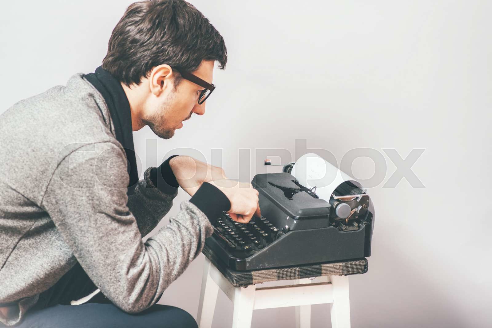 handsome journalist writing with typewriter | Stock image | Colourbox