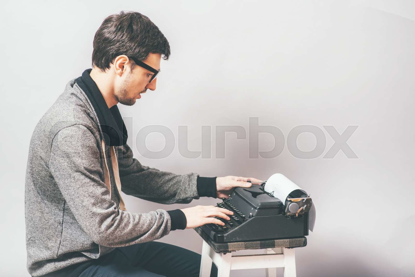 handsome journalist writing with typewriter | Stock image | Colourbox