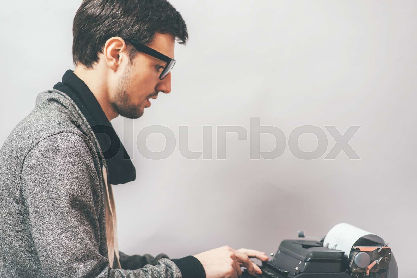 handsome journalist writing with typewriter | Stock image | Colourbox