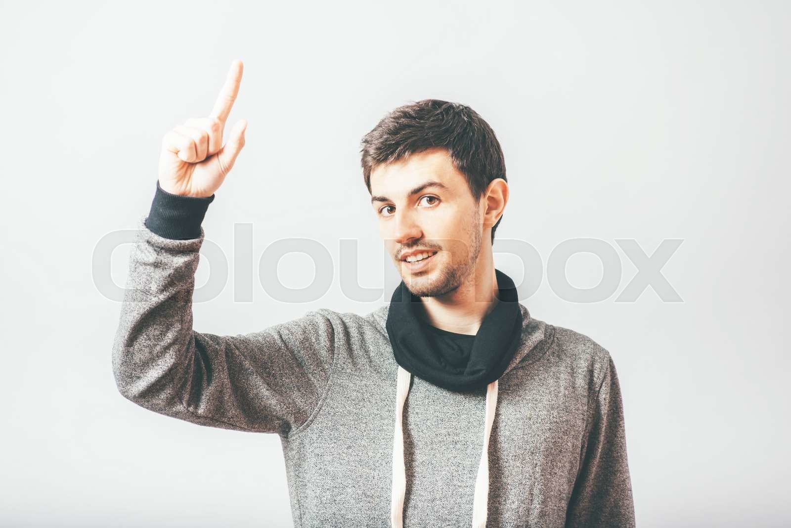 man shows his index finger up | Stock image | Colourbox
