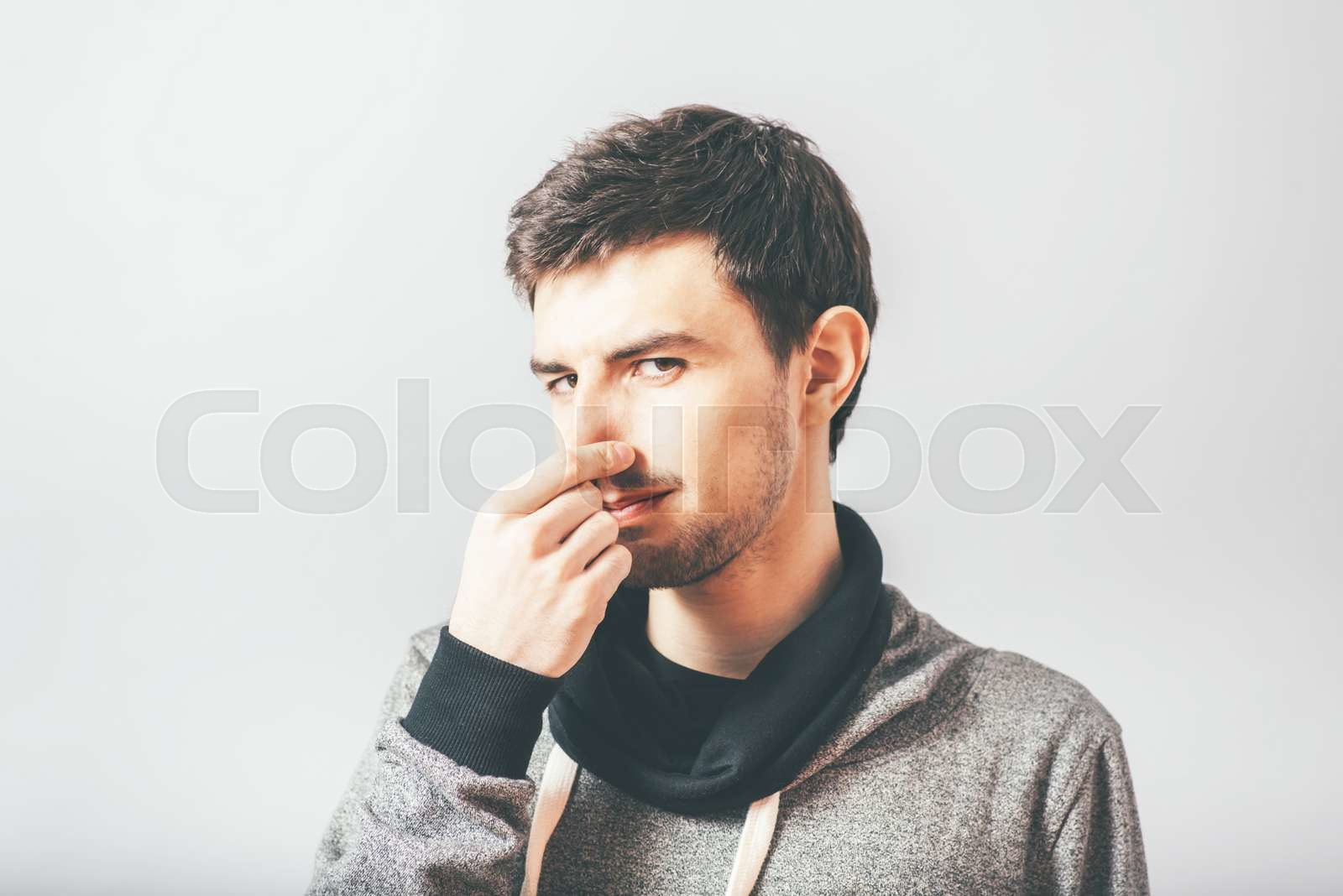 man closes nose hand | Stock image | Colourbox